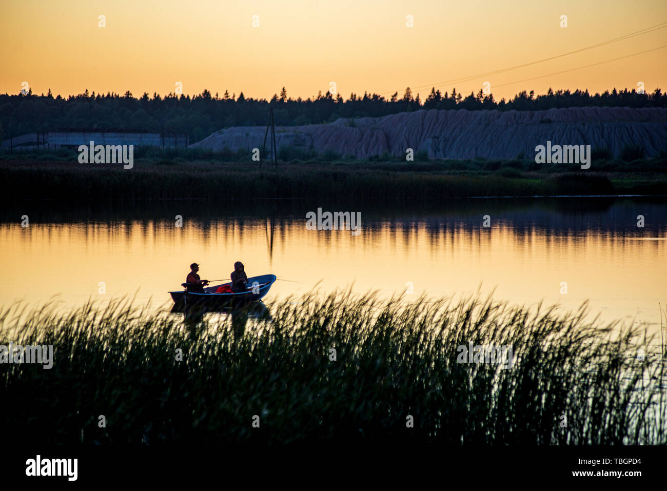 calm countryside lake river in sunset with fisherman in a boat Stock ...