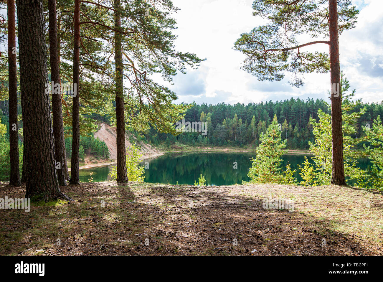 calm countryside lake river with cloud reflections in water and green ...