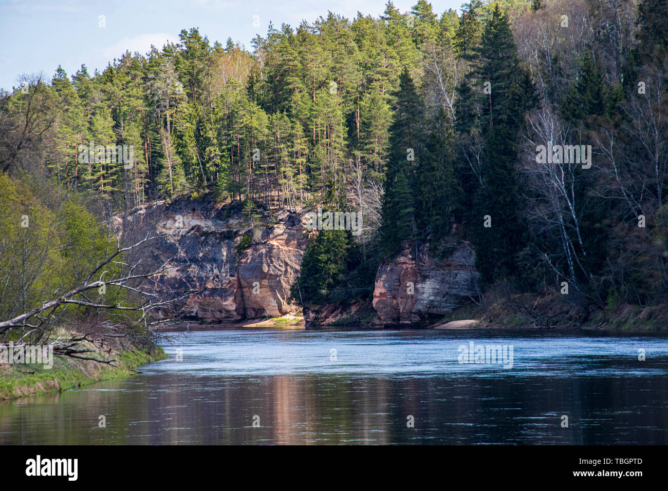 calm countryside lake river with cloud reflections in water and green ...