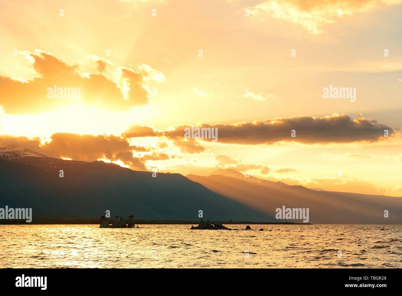 Mono Lake sunset with light ray through mountains Stock Photo - Alamy