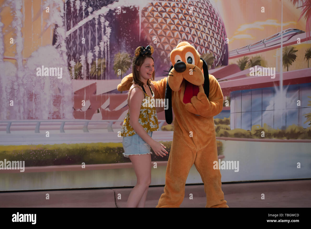 Orlando, Florida . March 27, 2019. Pluto hugging girl at Epcot in Walt ...