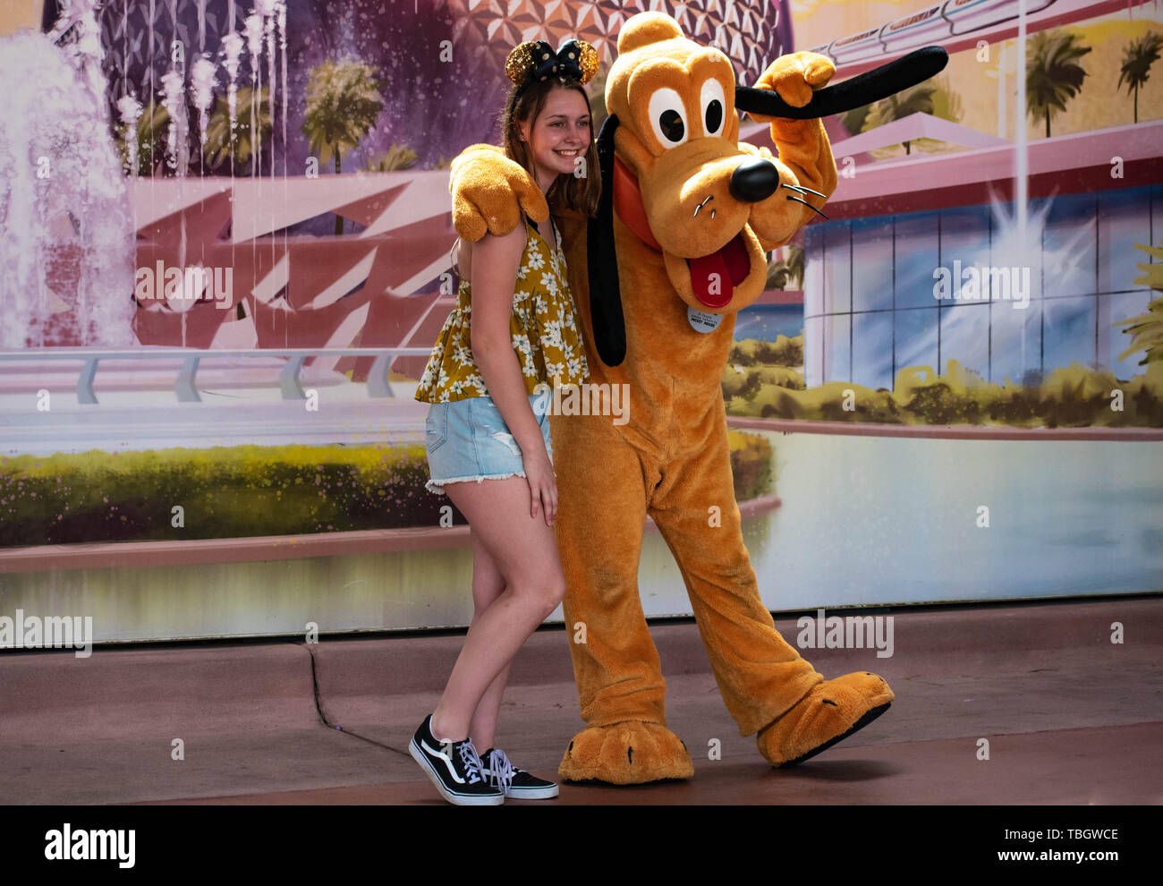 Orlando, Florida . March 27, 2019. Pluto hugging girl at Epcot in Walt ...