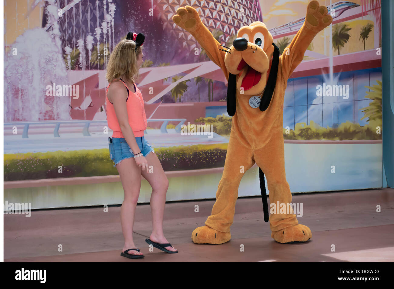 Orlando, Florida . March 27, 2019. Pluto playing with girl at Epcot in ...