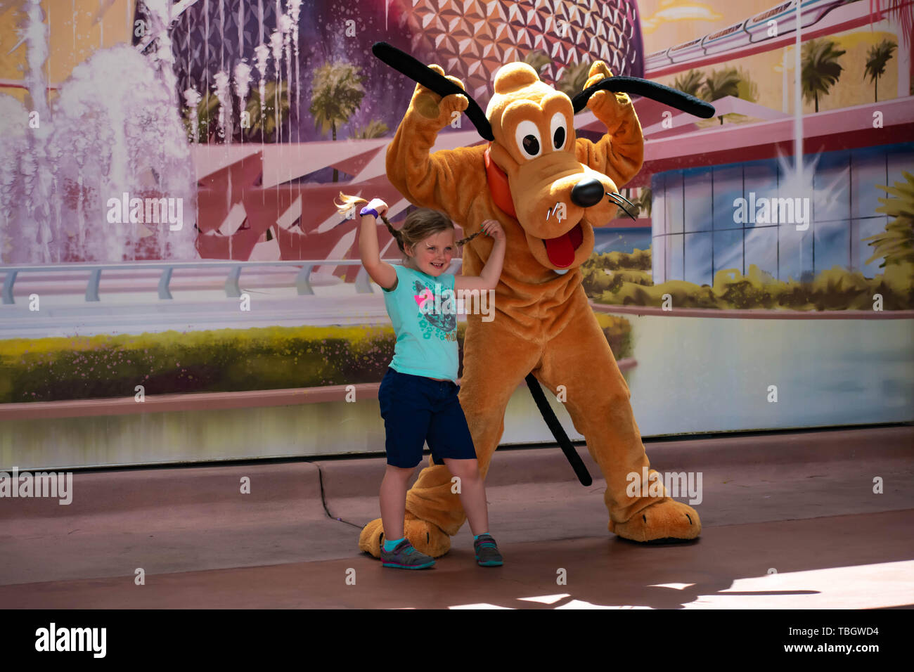 Orlando, Florida . March 27, 2019. Pluto playing with little girl at ...