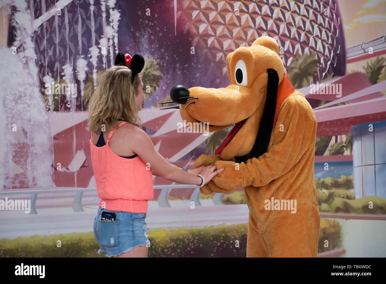 Orlando, Florida . March 27, 2019. Pluto taking the hands of girl at ...