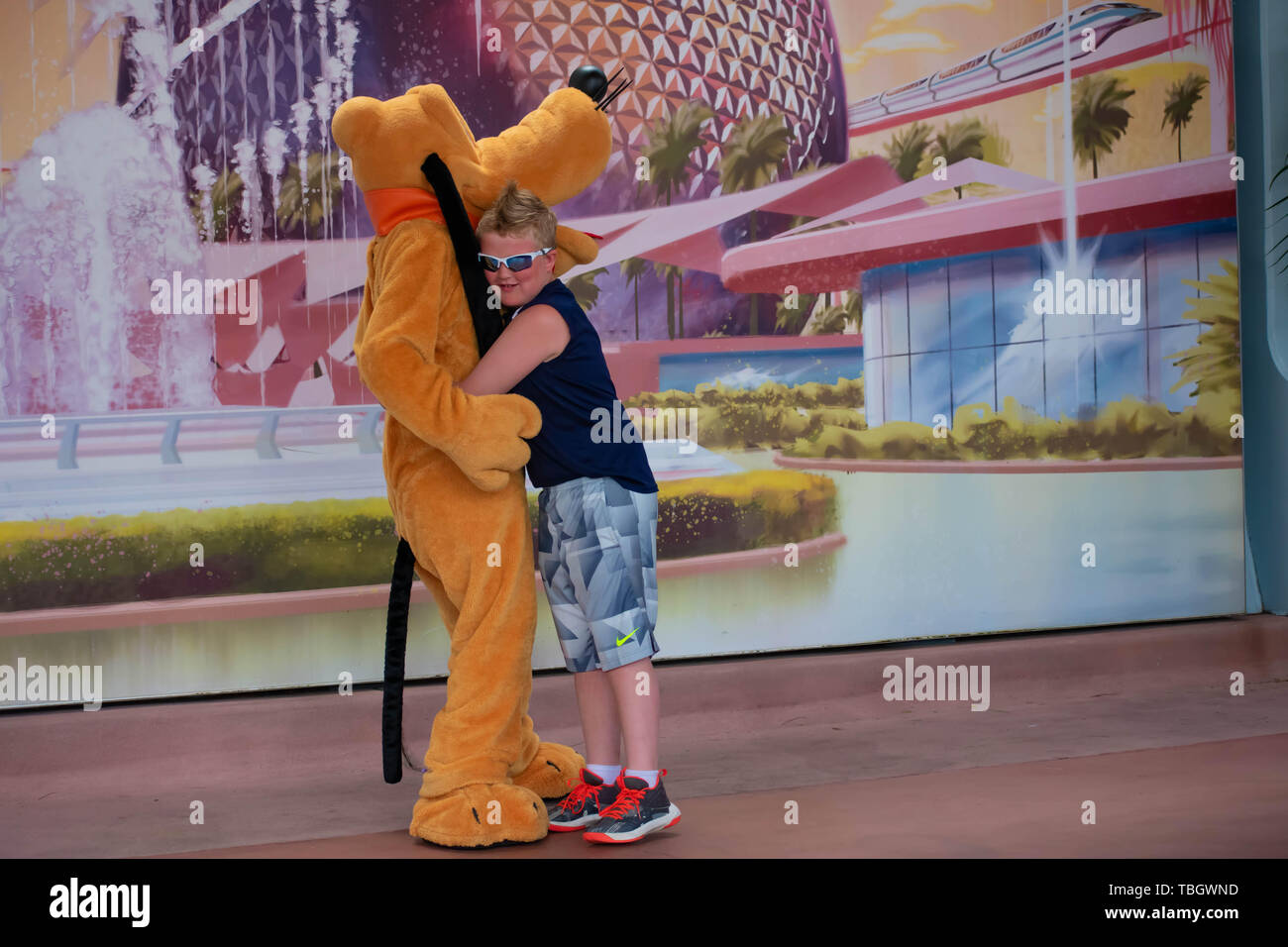 Orlando, Florida . March 27, 2019.Pluto hugging little boy at Epcot in ...