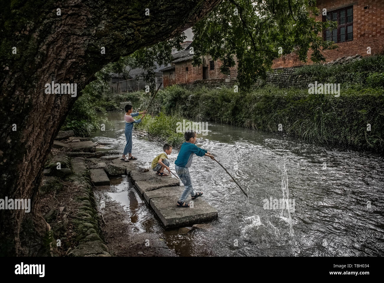 Playing kids in the harbor Stock Photo - Alamy