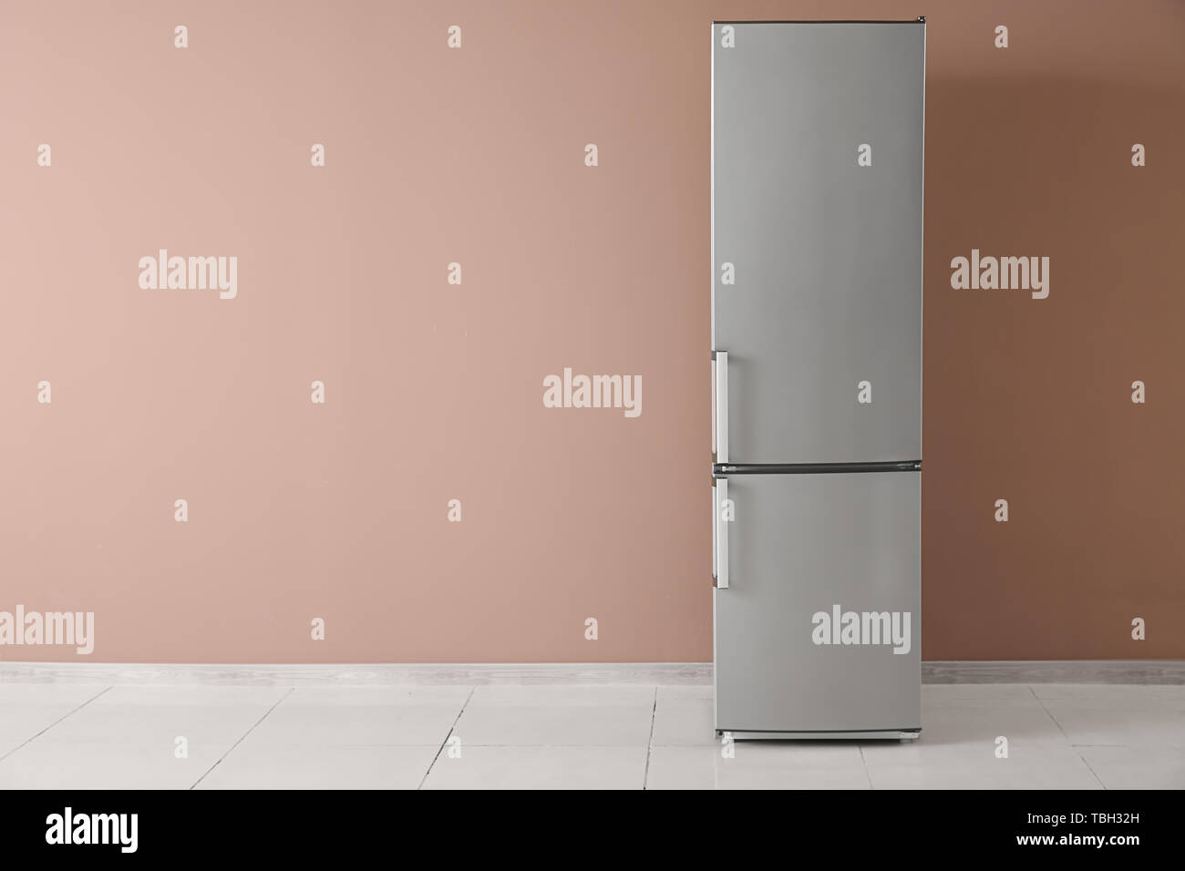 Modern fridge near color wall Stock Photo - Alamy