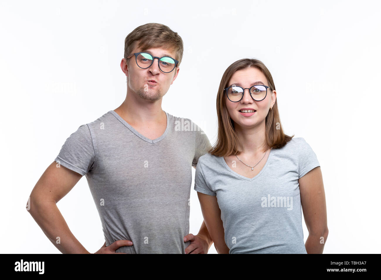 Education, people concept - a couple of young people in glasses look ...