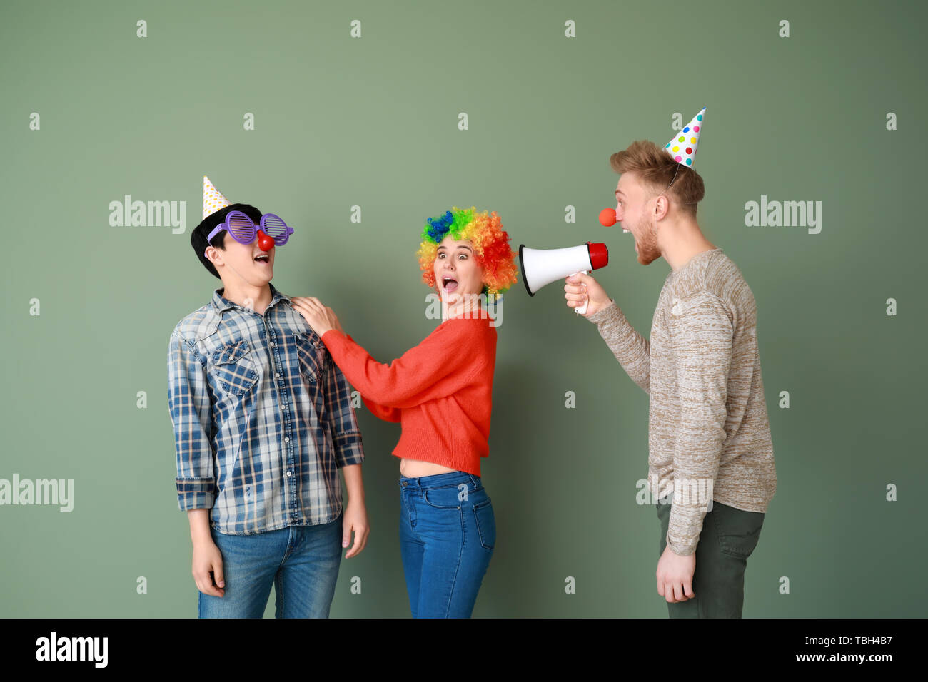 Funny man with megaphone shouting at his friends against color ...