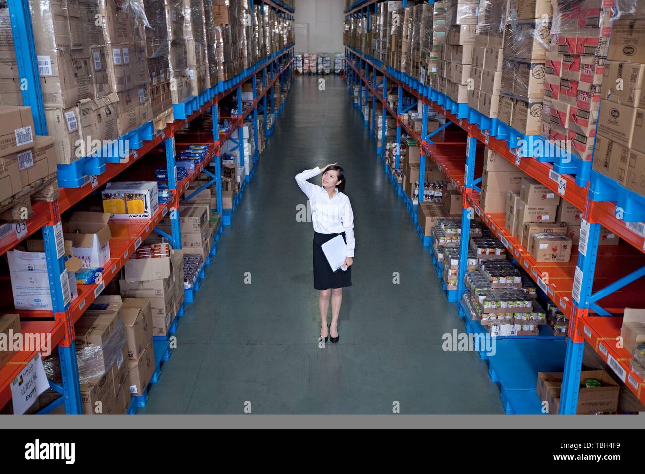 Old woman stacking shelves hi-res stock photography and images - Alamy