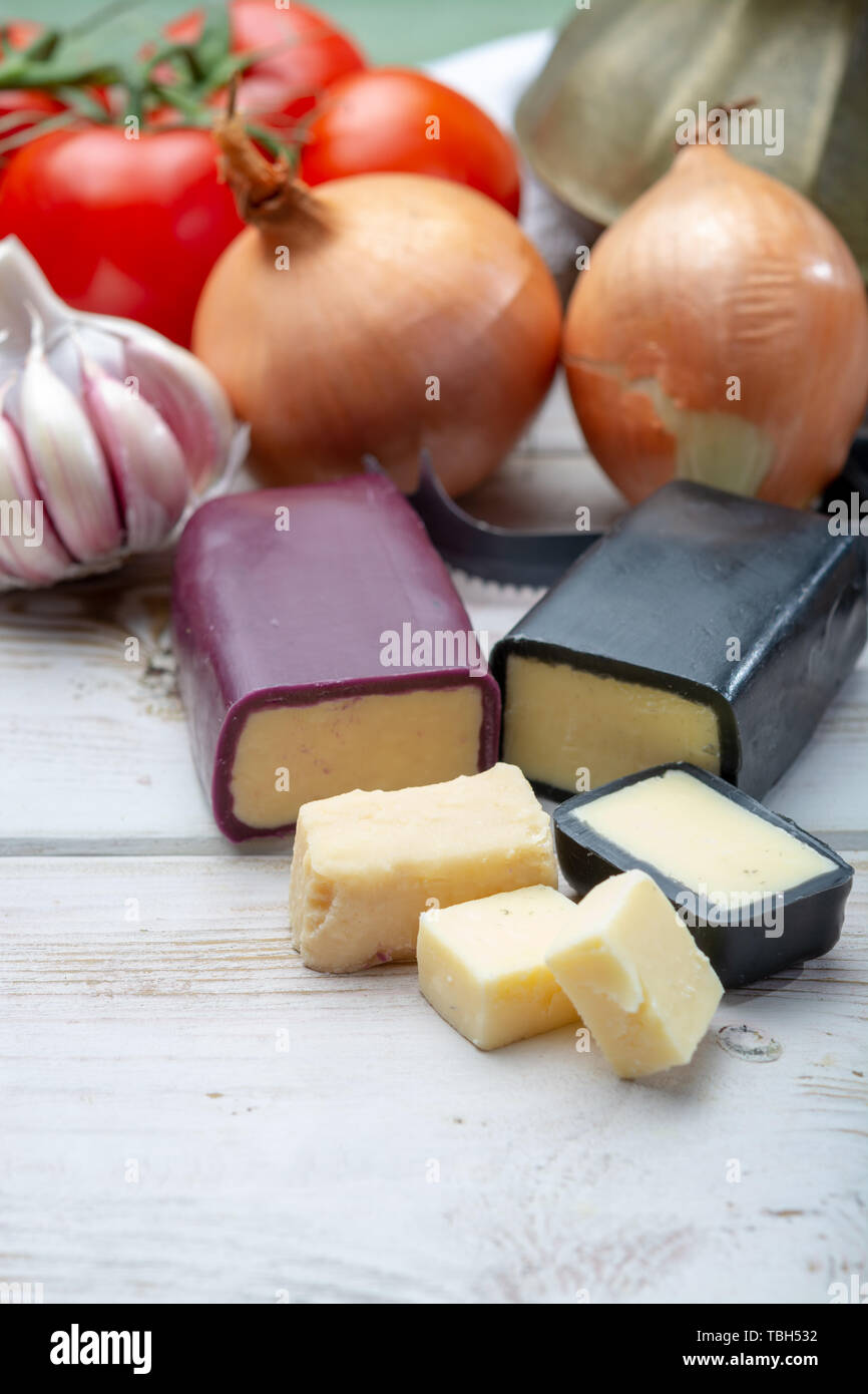 Mini black and dark red waxed cheddar cheeses with strong flavor made ...