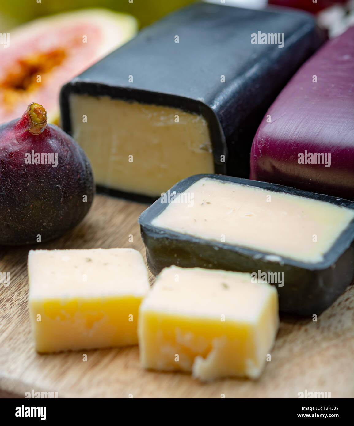 Mini black and dark red waxed cheddar cheeses made from West Country ...