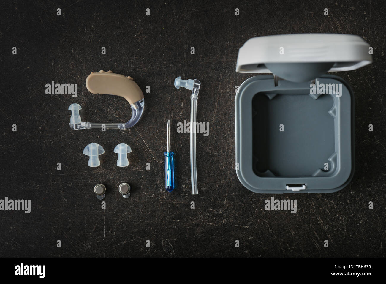 Hearing aid with accessories on dark background Stock Photo - Alamy