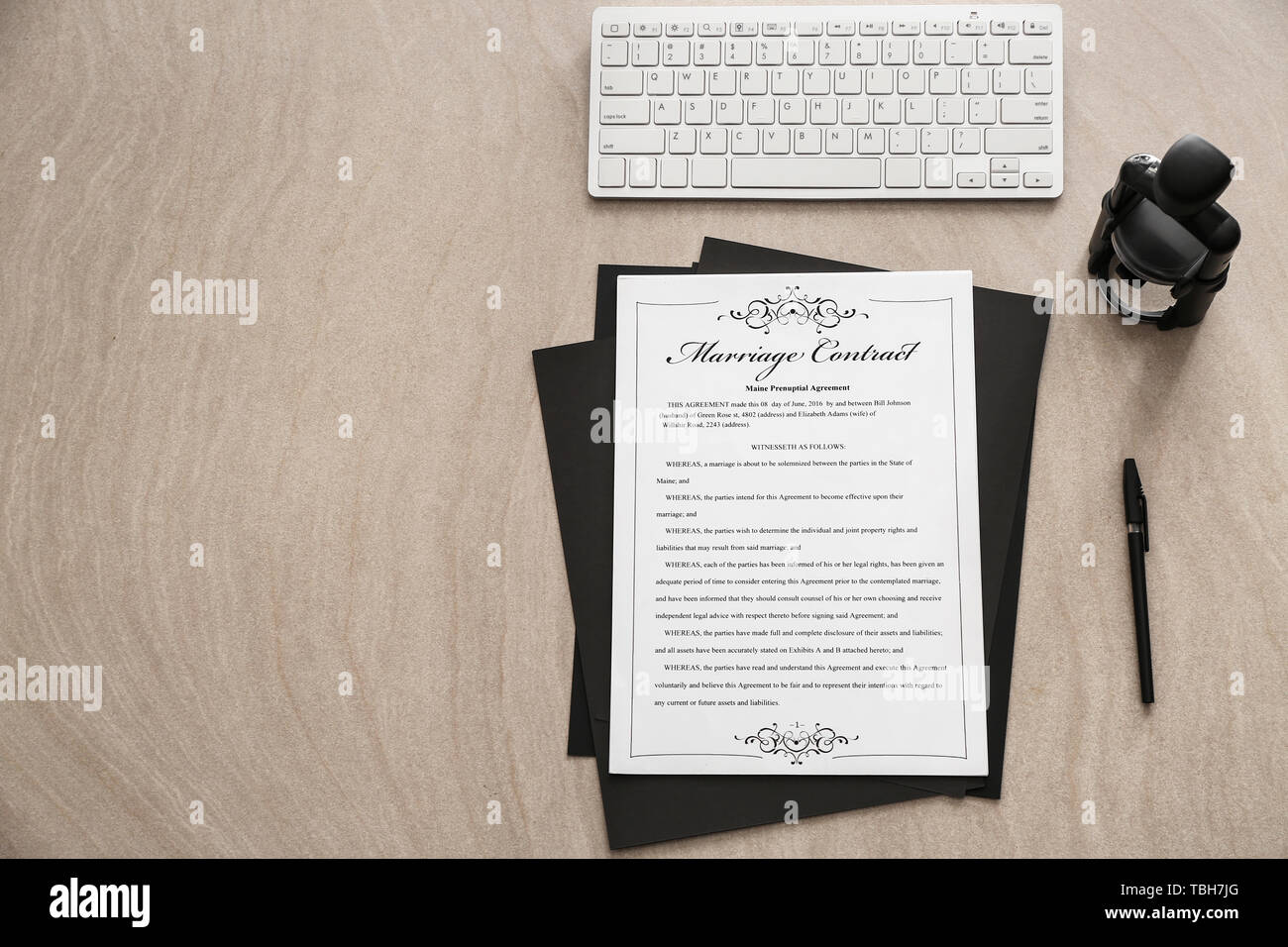 Marriage contract, computer keyboard and stamp on table of notary ...