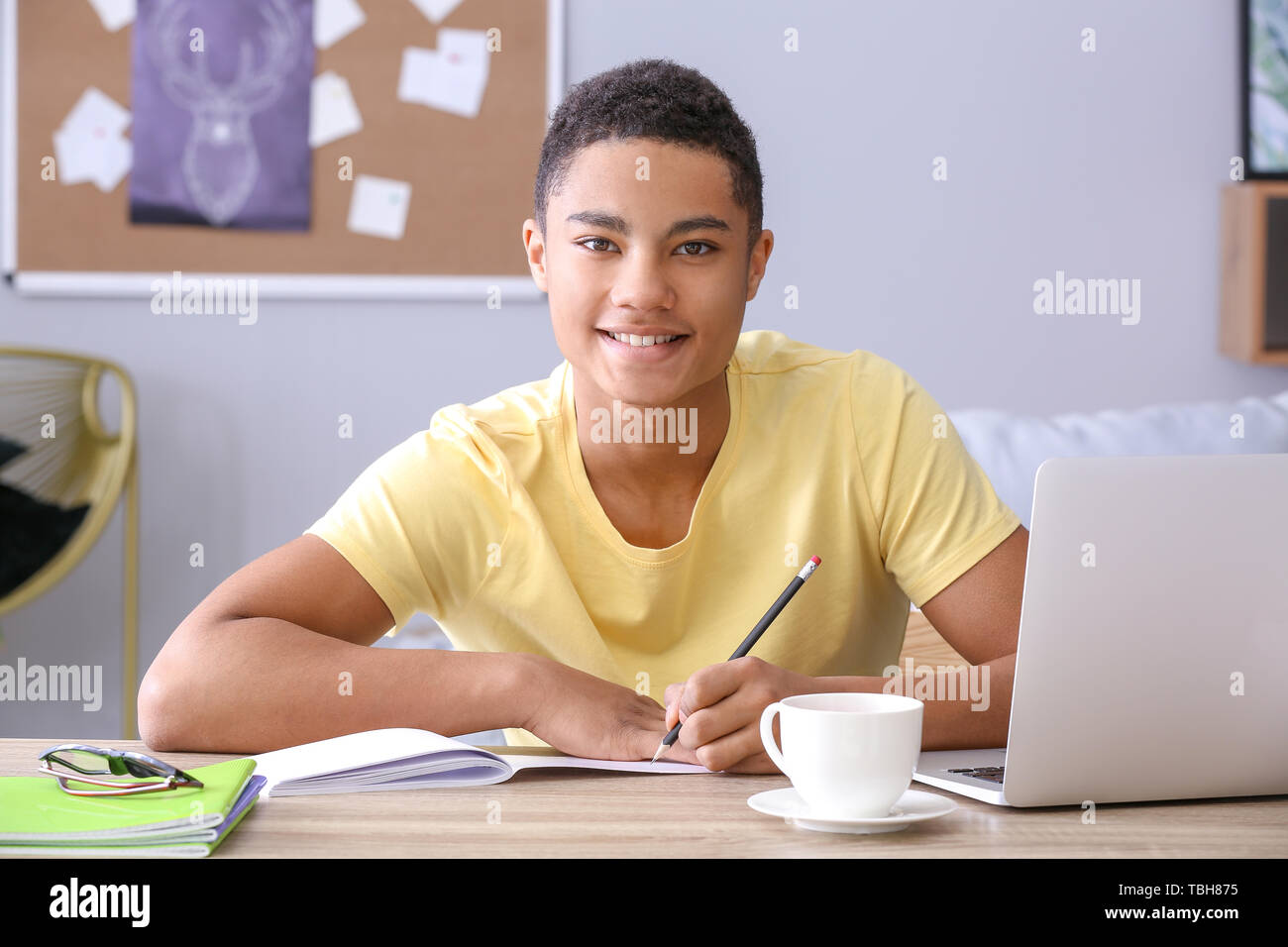 African-American teenage boy doing homework Stock Photo - Alamy