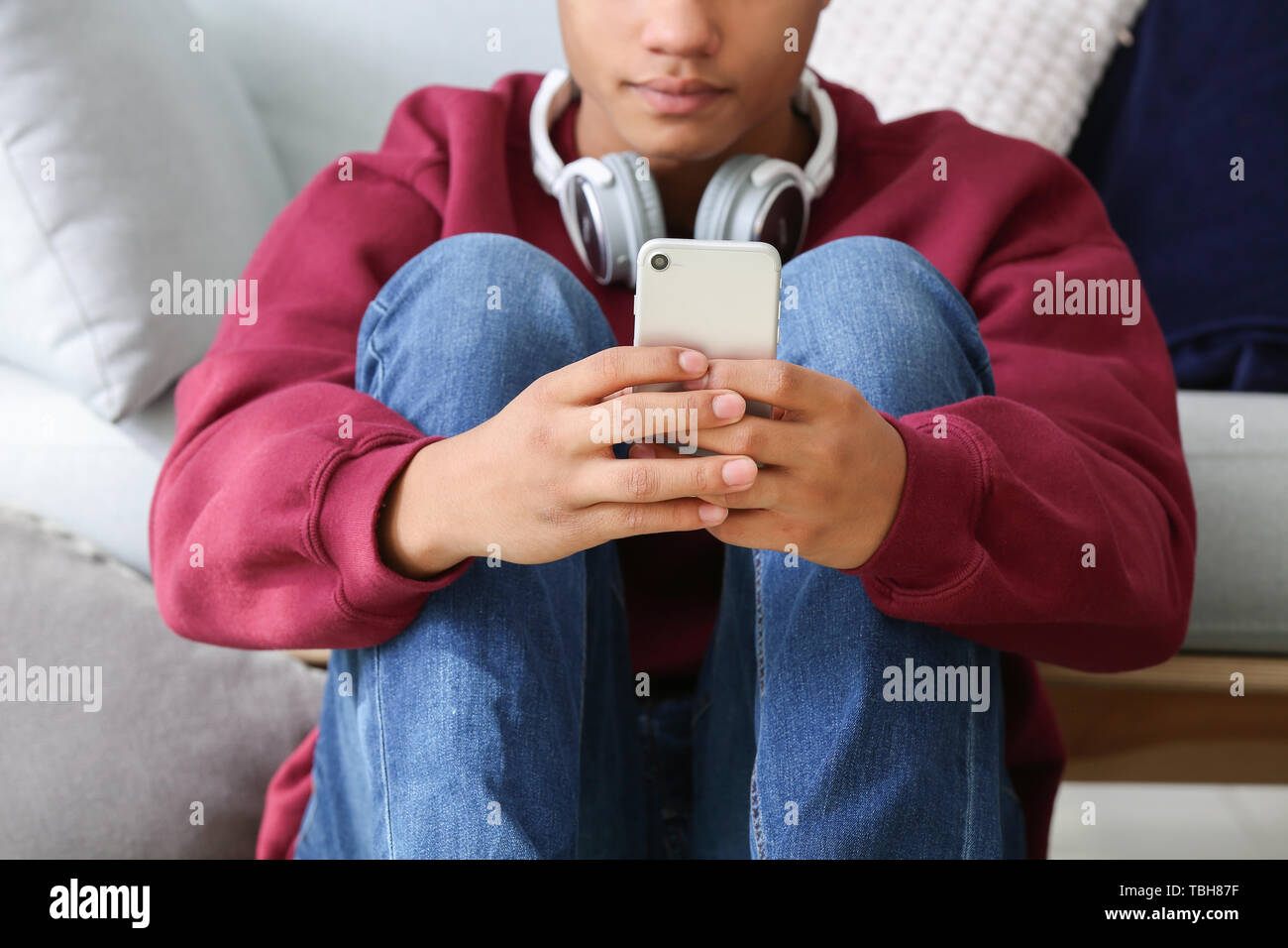 African-American teenage boy using mobile phone at home Stock Photo - Alamy