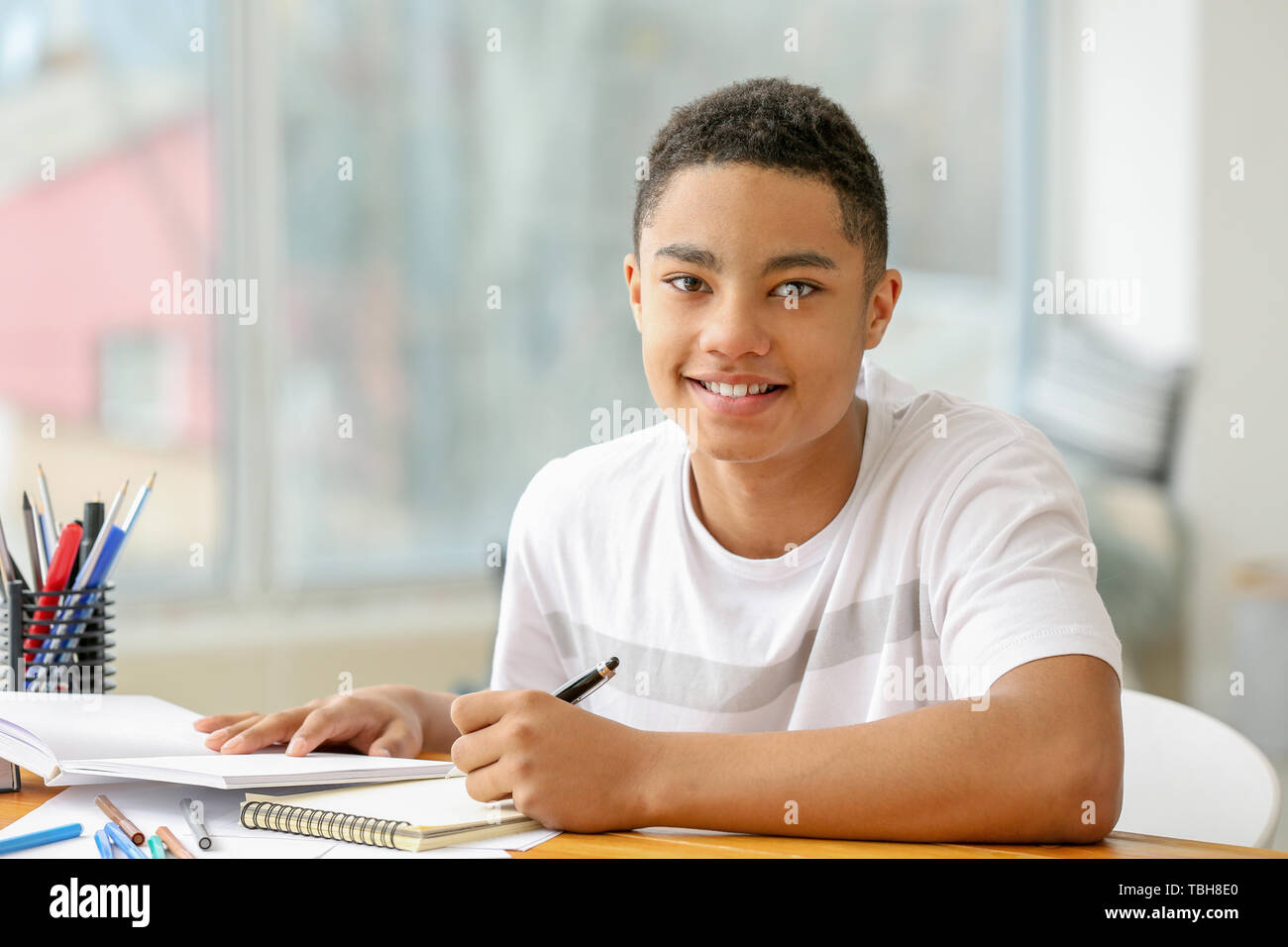 African-American teenage boy doing homework Stock Photo - Alamy