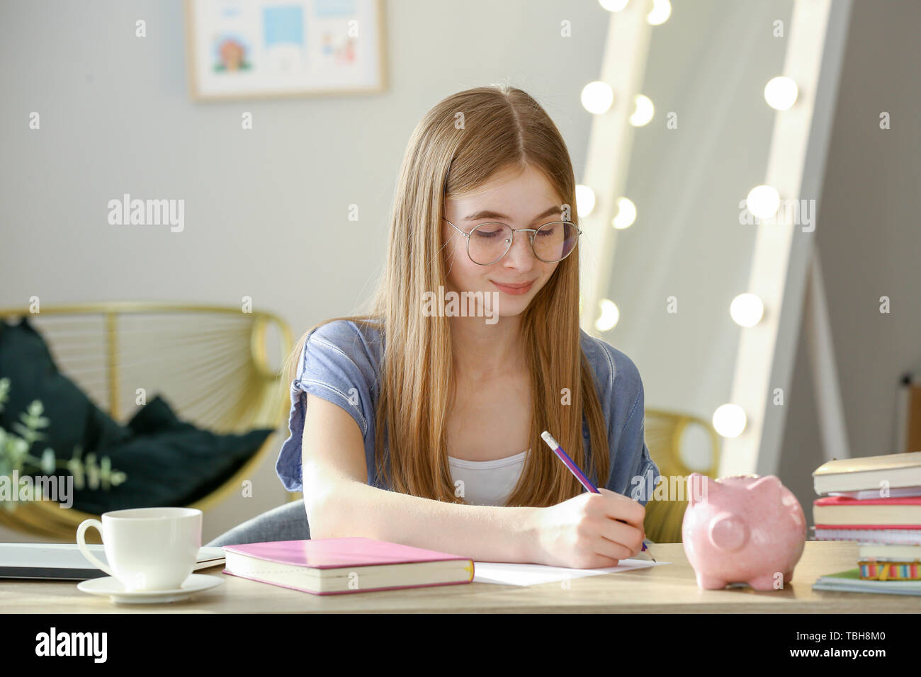 Cute teenage girl doing homework Stock Photo - Alamy