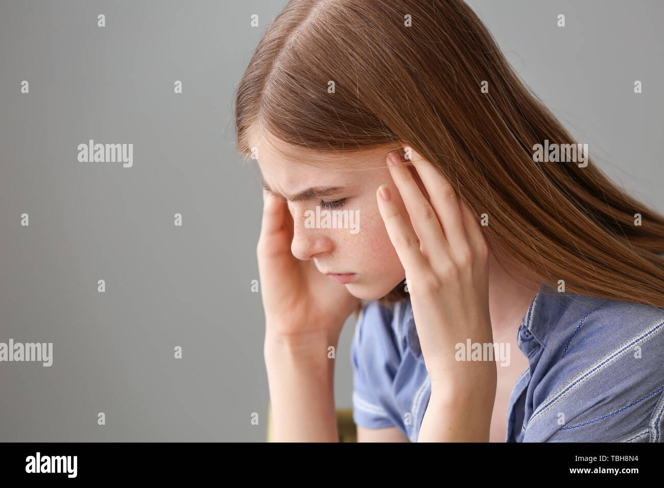 Sad teenage girl on grey background Stock Photo - Alamy