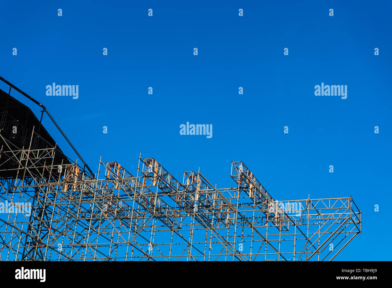 Metallic structure of assembled pipes to hold a stage, blue sky ...