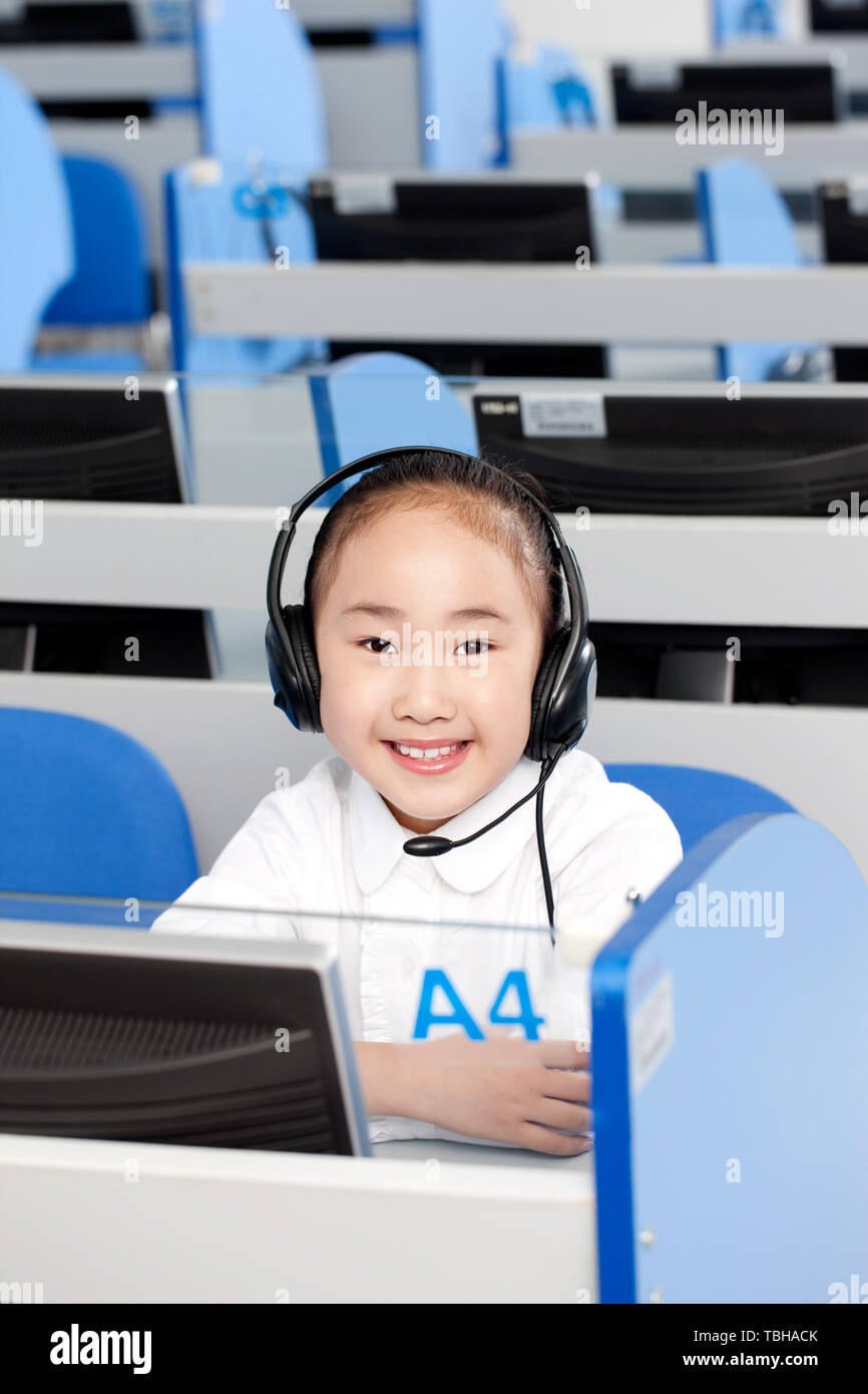 Three primary school students are in class in the classroom Stock Photo ...