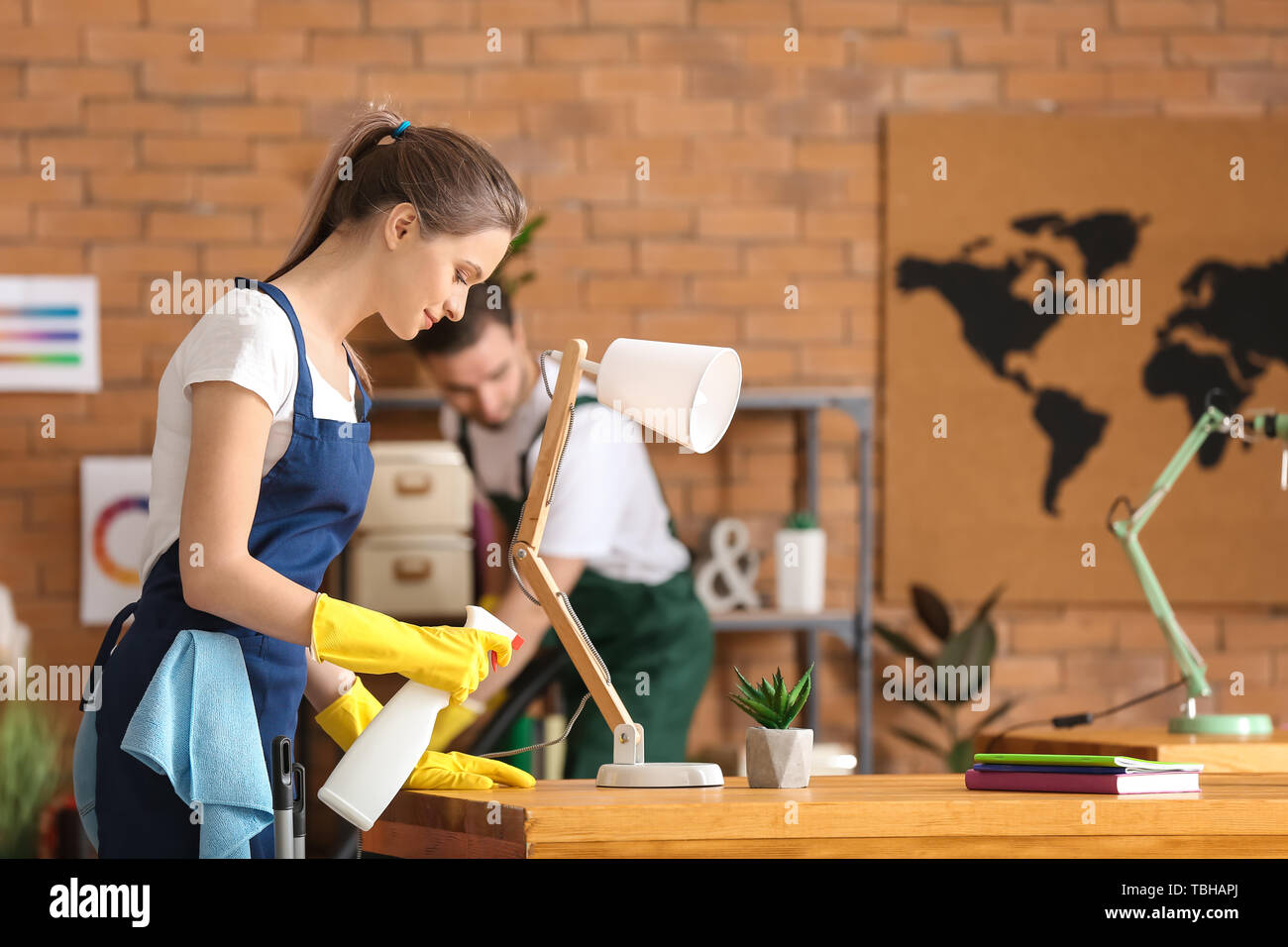 Female janitor cleaning office Stock Photo - Alamy