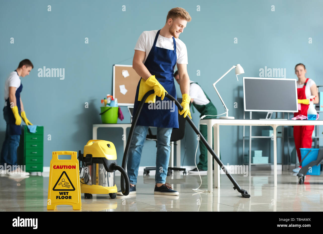 Team of janitors cleaning office Stock Photo - Alamy