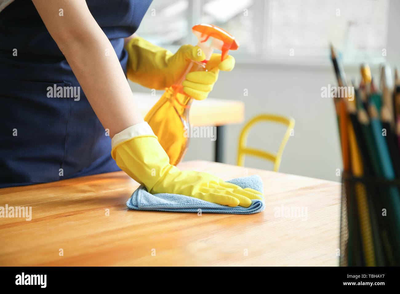 Female janitor cleaning table in office, closeup Stock Photo - Alamy