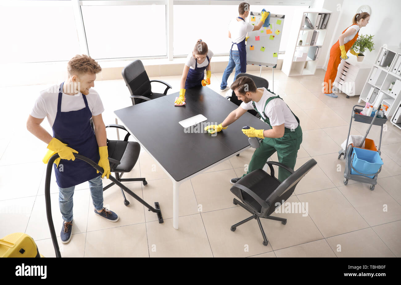 Team of janitors cleaning office Stock Photo - Alamy