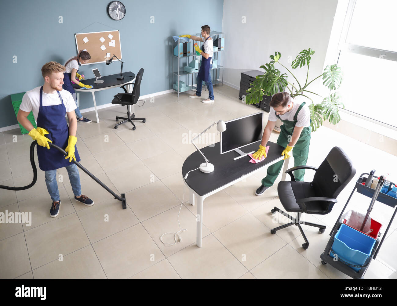 Team of janitors cleaning office Stock Photo - Alamy