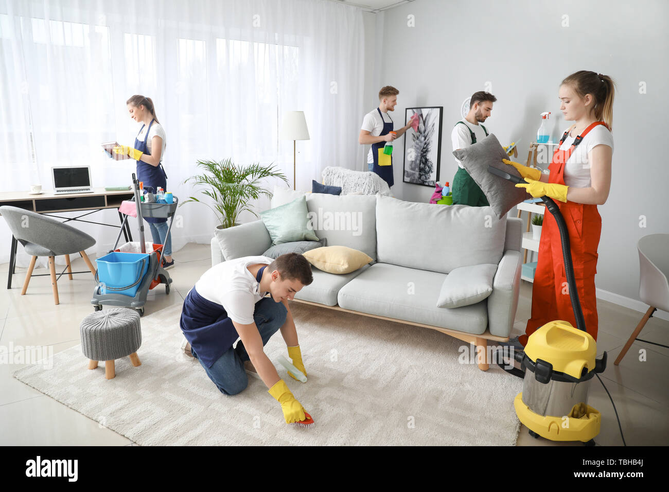 Team of janitors cleaning room Stock Photo - Alamy