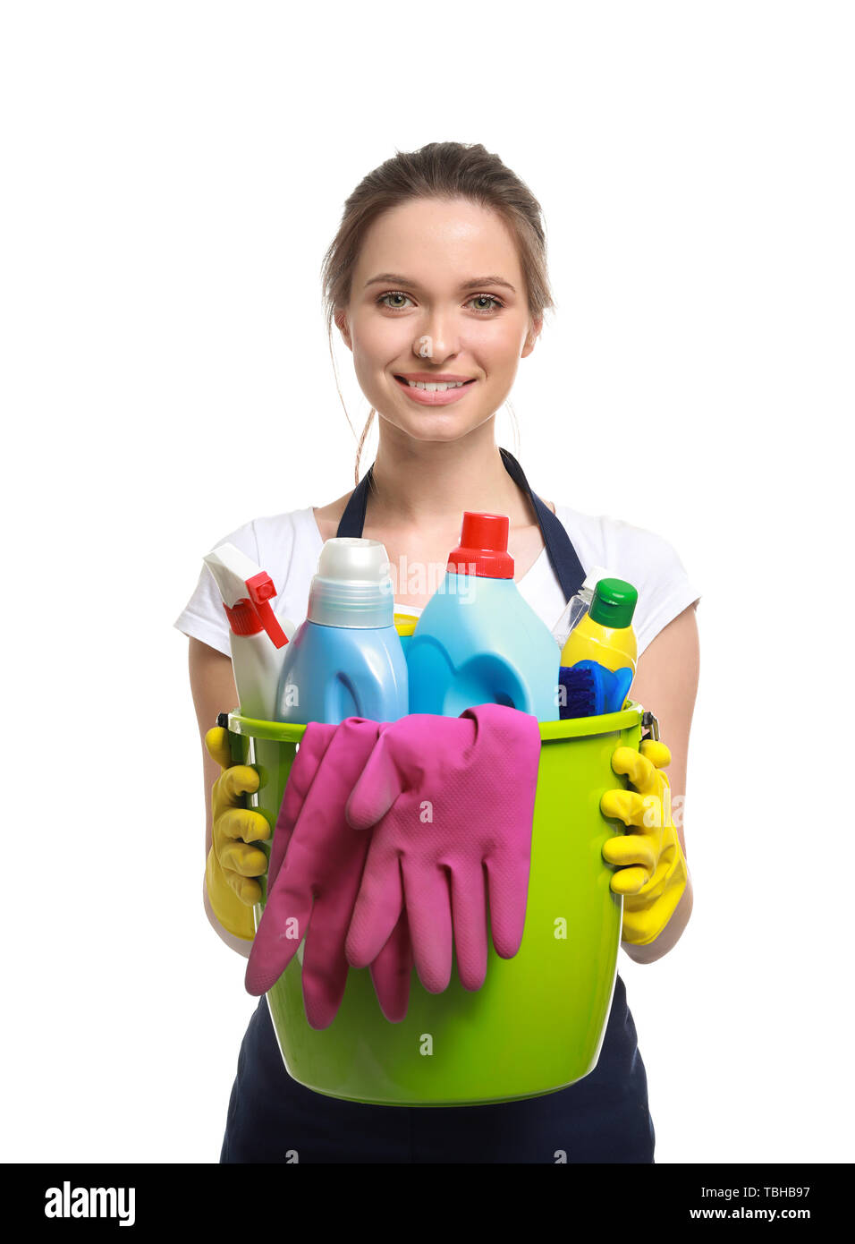 Portrait of female janitor with cleaning supplies on white background ...