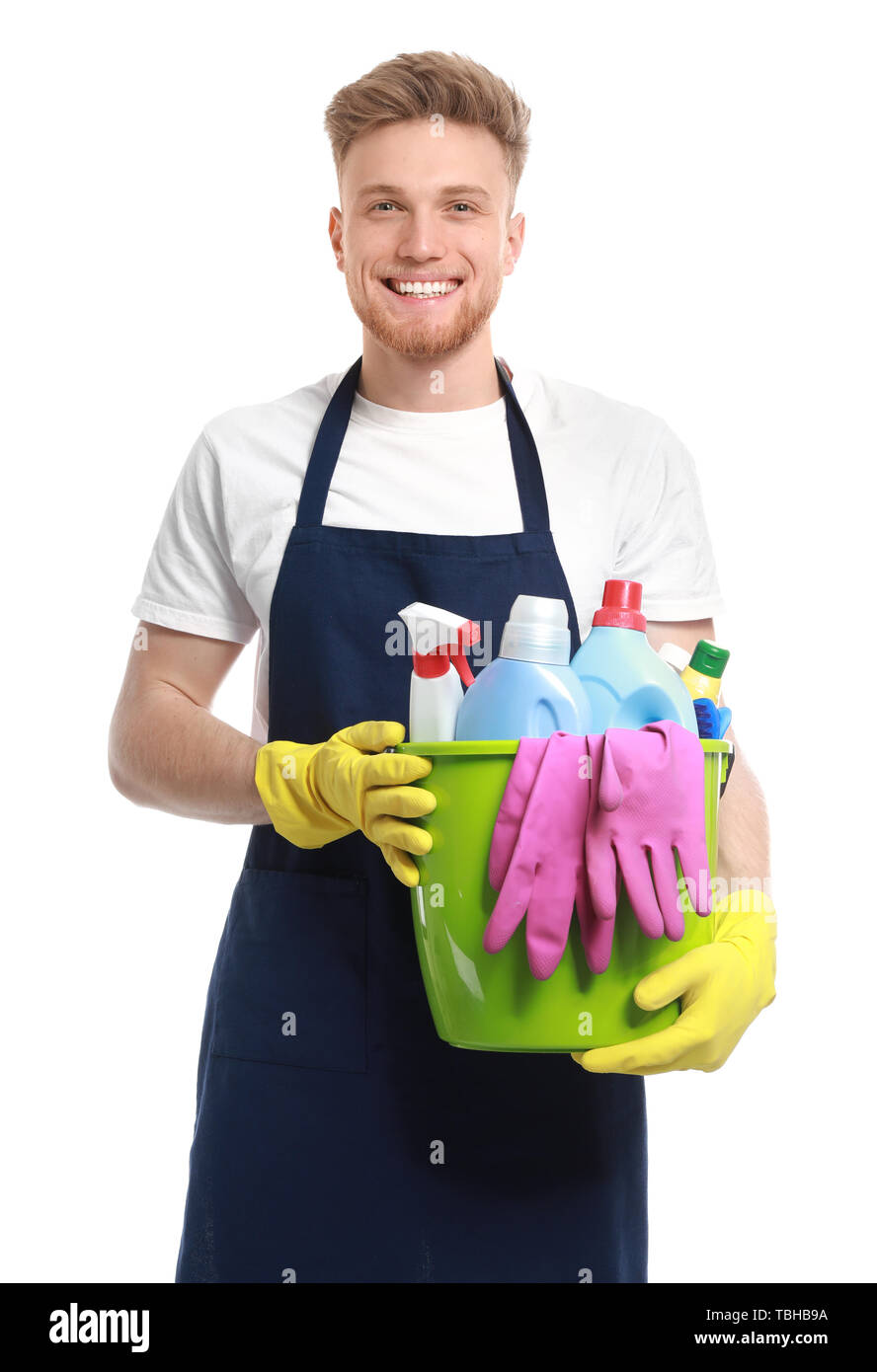 Portrait of male janitor with cleaning supplies on white background ...