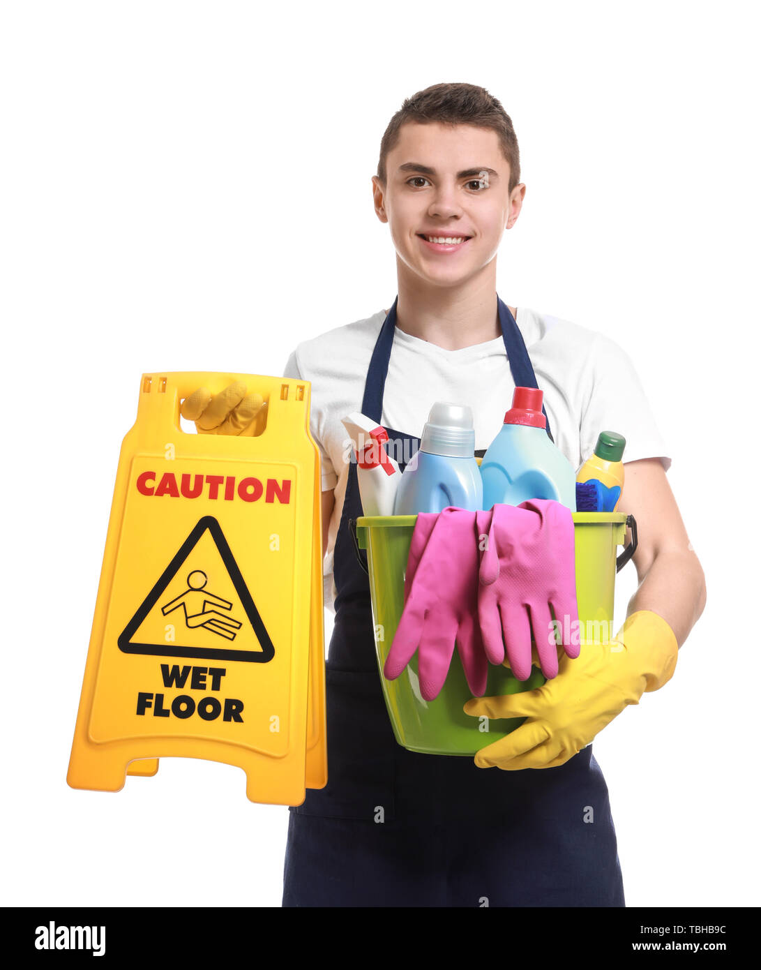 Portrait of male janitor with cleaning supplies and sign board on white ...
