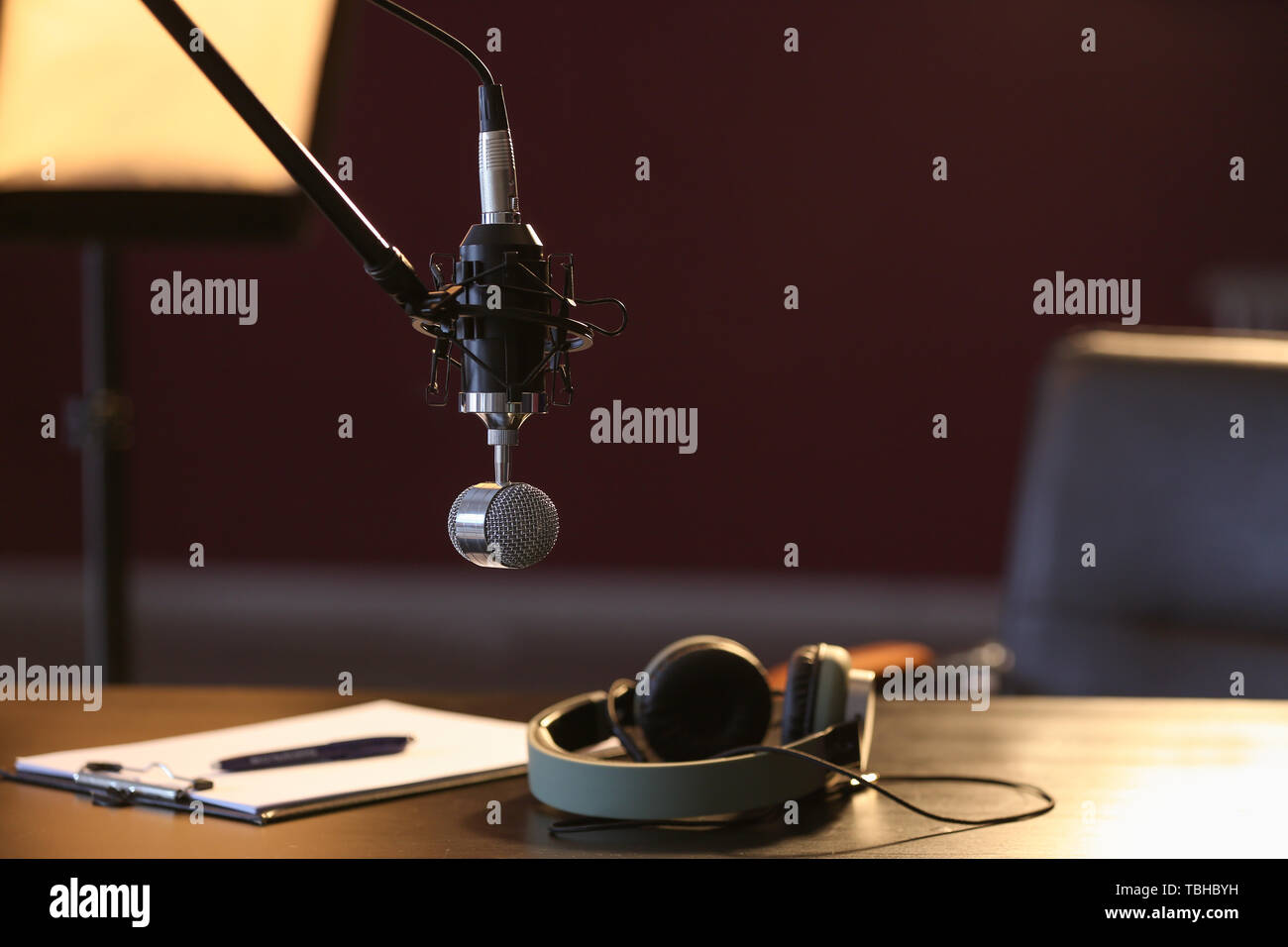 Table with headphones and microphone in radio station Stock Photo - Alamy
