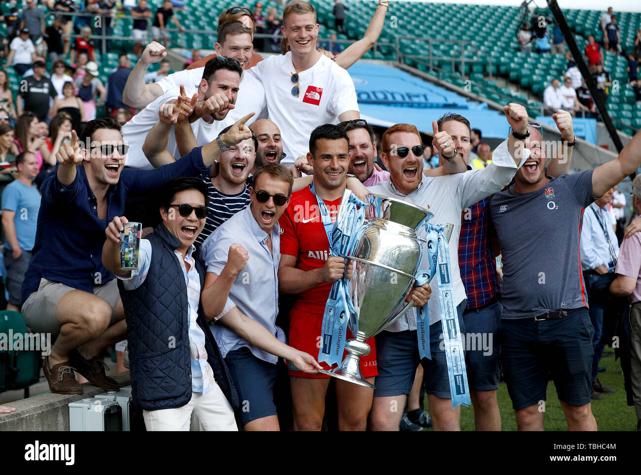 Saracens' Alex Lozowski celebrates with friends holding the trophy ...