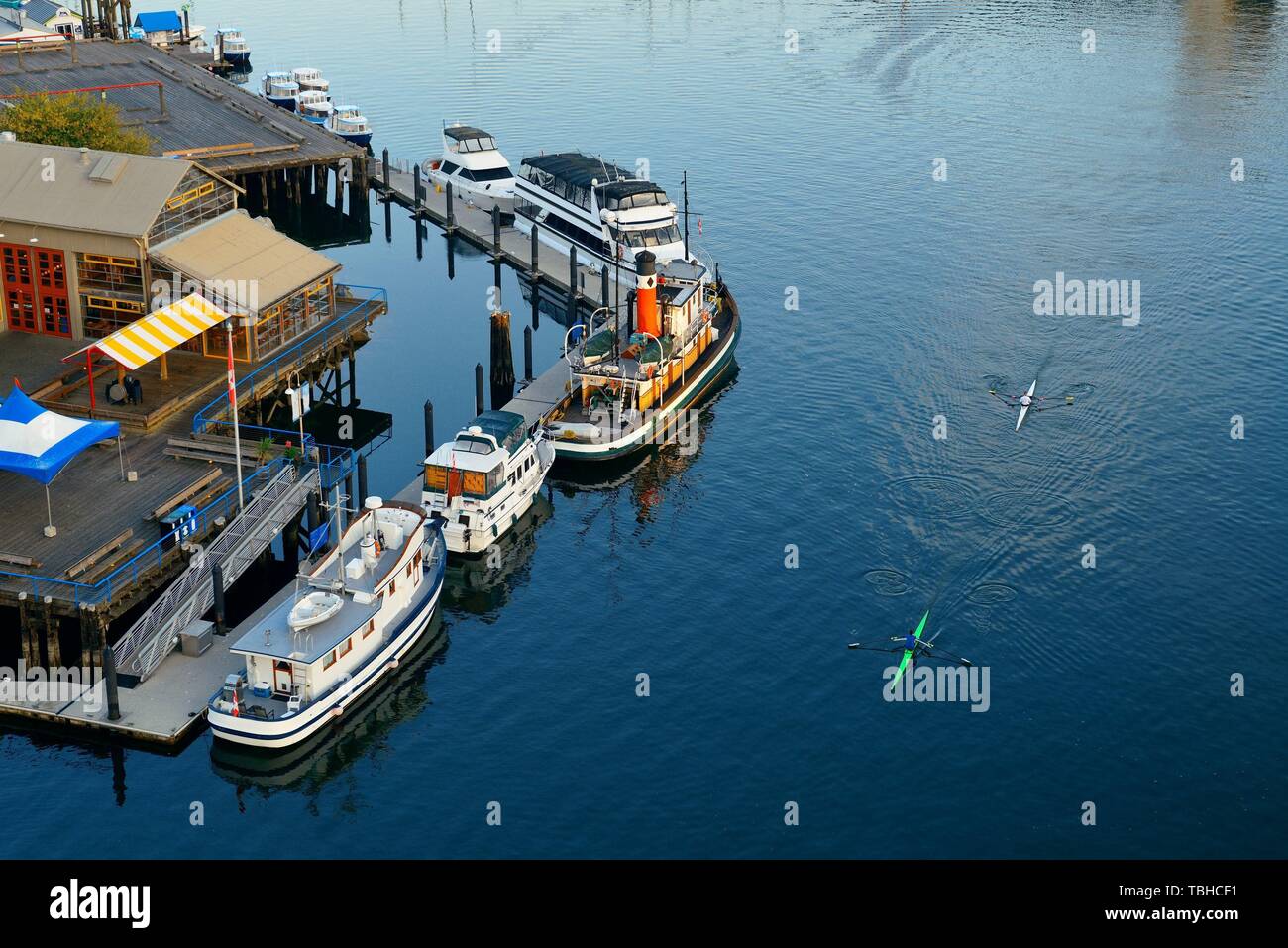 Vancouver harbor view with urban apartment buildings and bay boat in ...