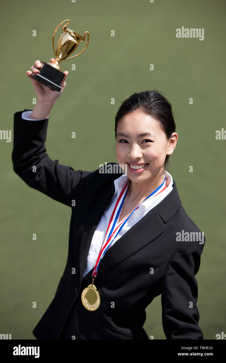 Woman hand raised gold medal hi-res stock photography and images - Alamy