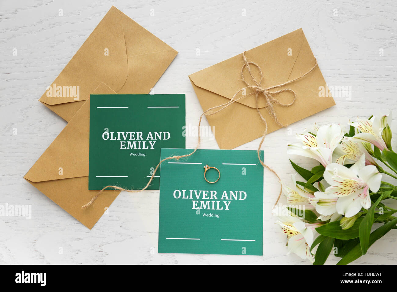 Wedding invitations on white table Stock Photo - Alamy
