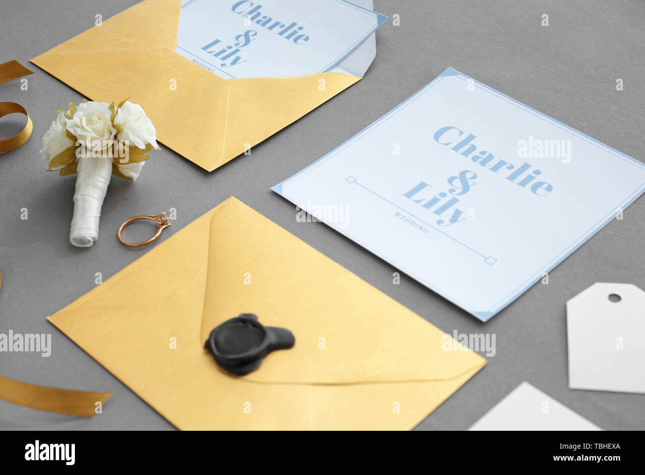 Wedding invitations on grey background Stock Photo - Alamy