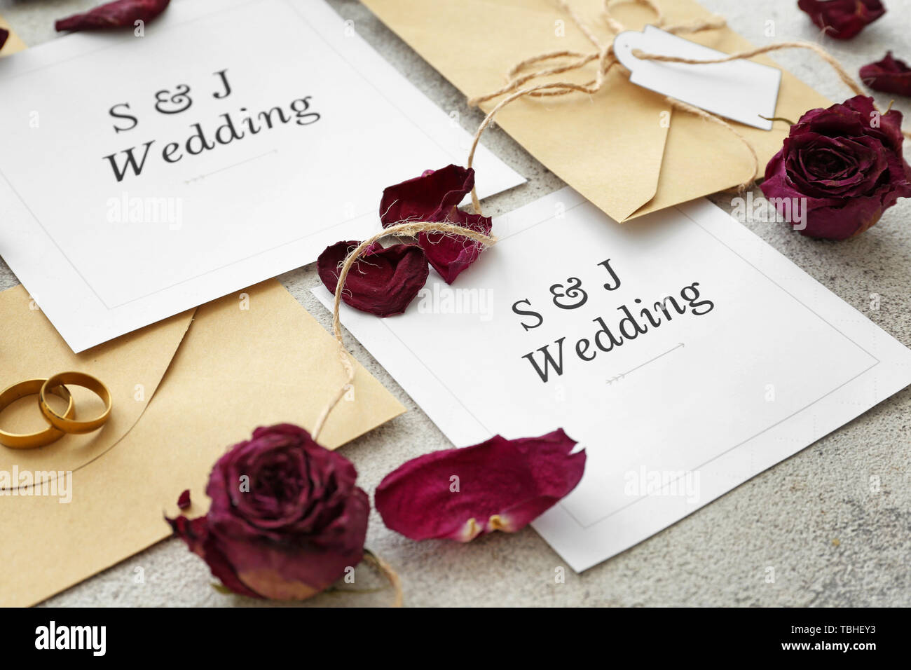 Wedding invitations on grey background Stock Photo - Alamy