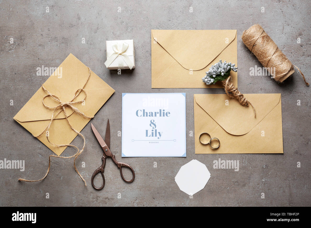 Wedding invitation on grey background Stock Photo - Alamy