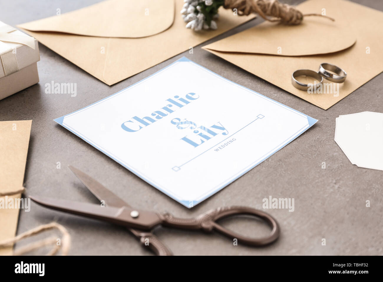 Wedding invitation on grey background Stock Photo - Alamy