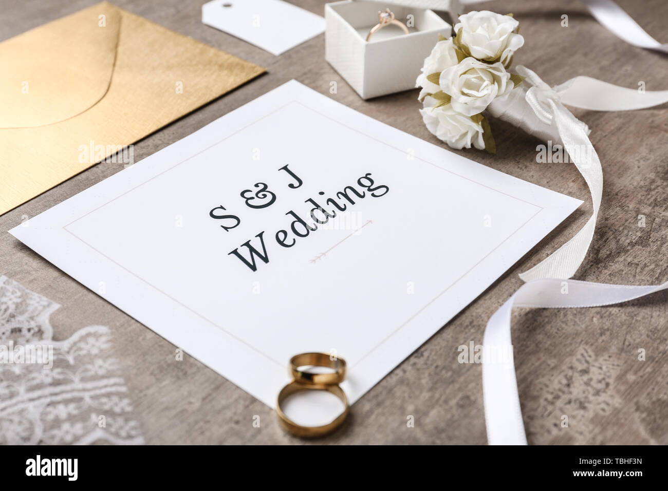 Wedding invitation on grey background Stock Photo - Alamy