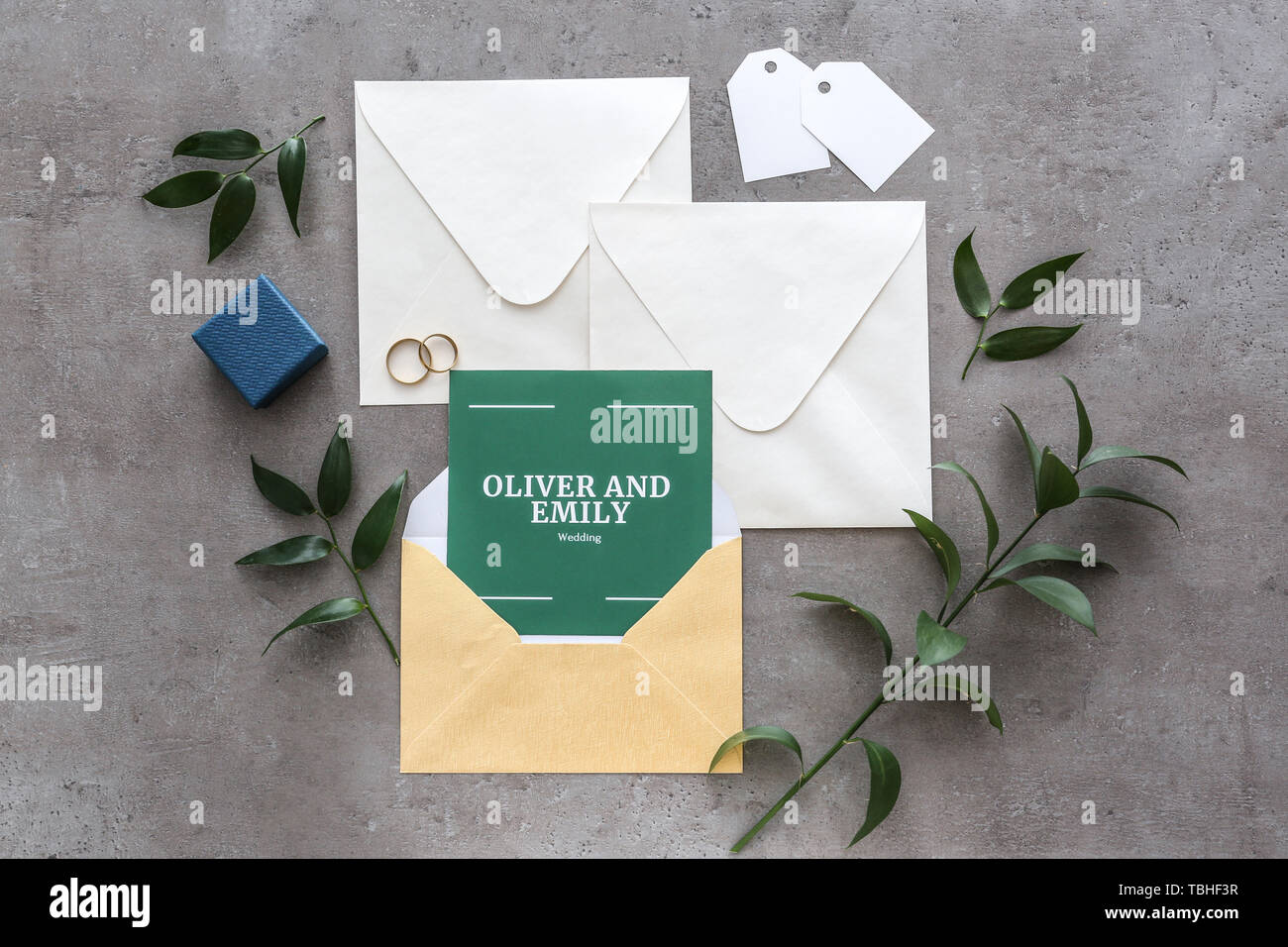 Wedding invitation on grey background Stock Photo - Alamy