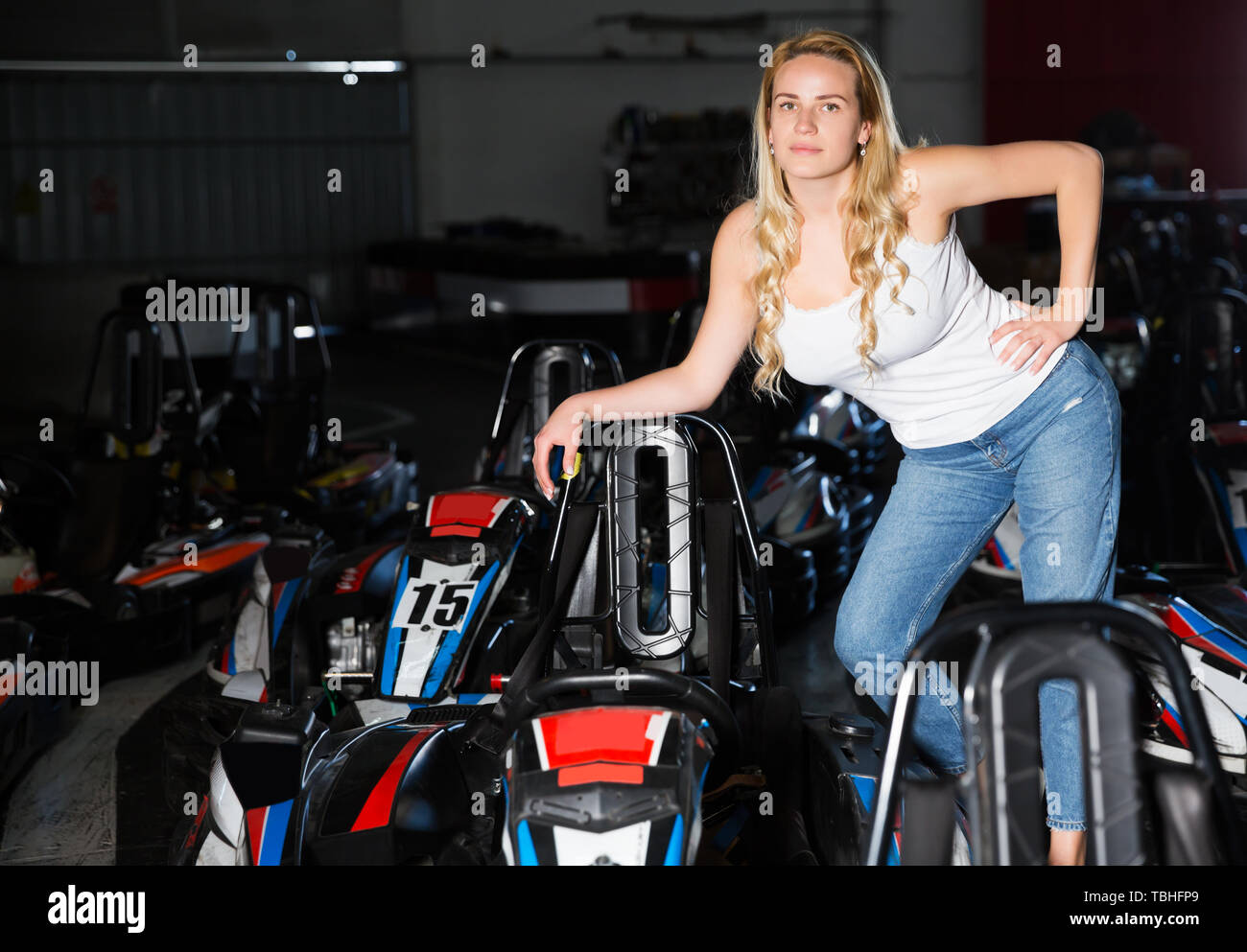 female model posing near racing cars at cart circuit Stock Photo - Alamy