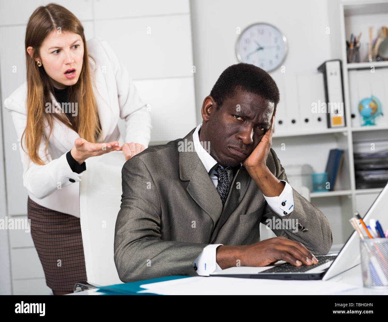 Angry female boss screaming to young male manager during working in ...