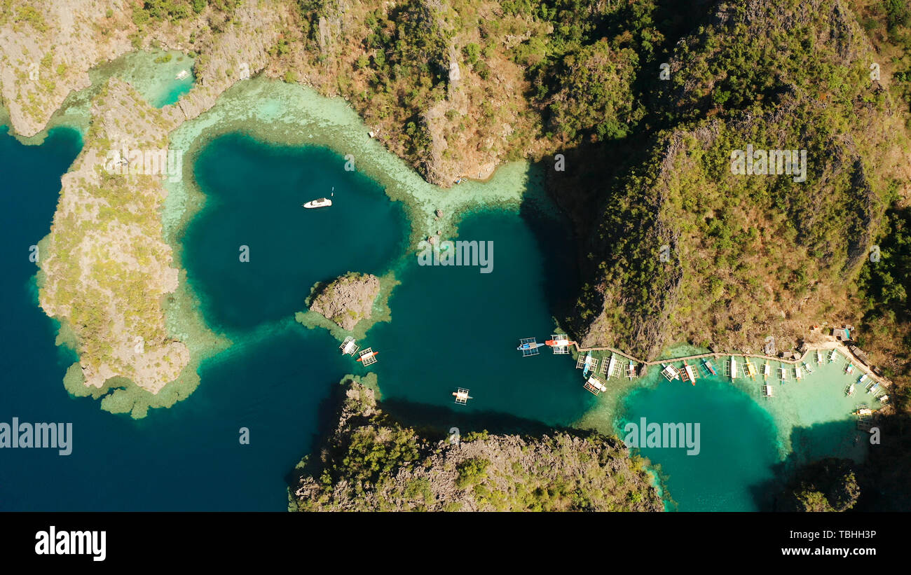 Aerial view tourist boats in lagoon. Kayangan Lake. lagoons, mountains ...