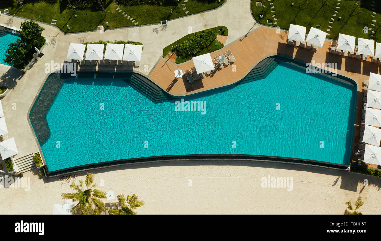 Luxury Resort Pool, top view. Swimming pool with umbrellas and sun beds ...